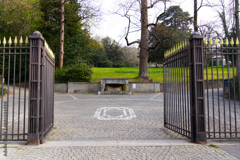 Parc de Mon Repos with open iron gate at City of Lausanne on a blue and ...