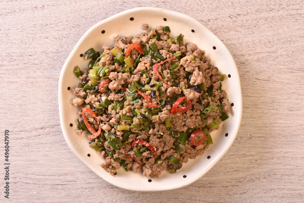 Sauteed minced pork with chive flowers in salted black bean is a ...