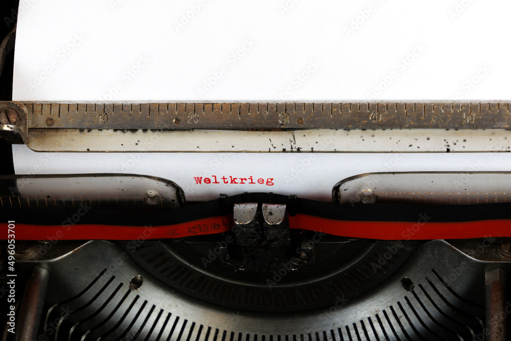 The German word Weltkrieg written in red on an old mechanical ...