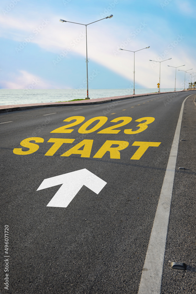 Start to 2023 written on the road on beach background with blue sky ...
