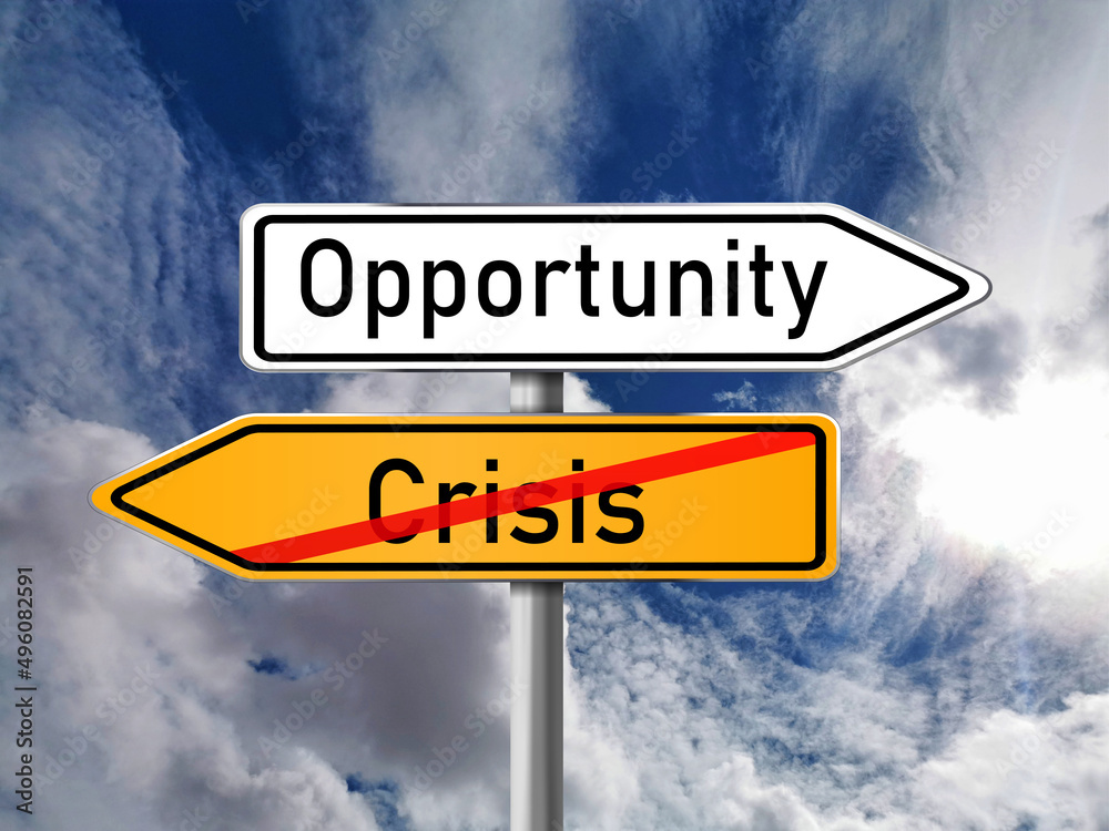 Road sign with two directions, Opportunity and crisis on blue sky ...
