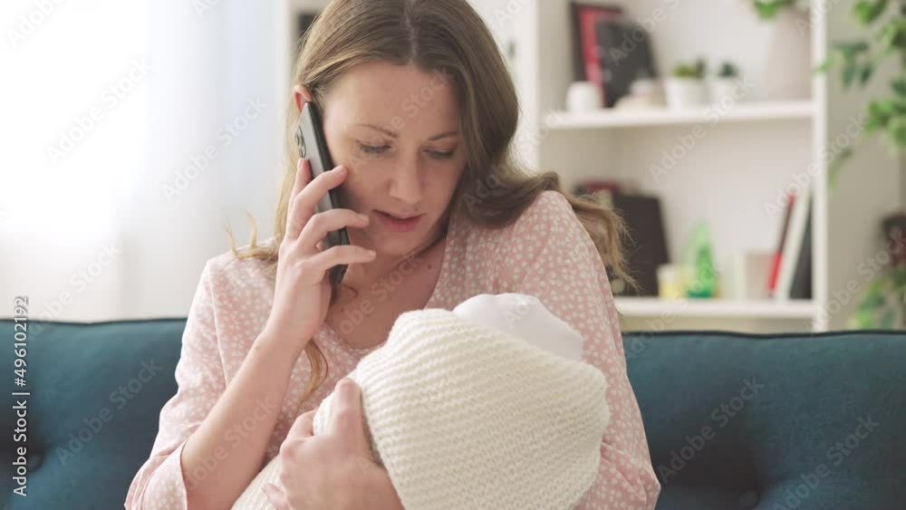 Anxious mother rocking crying newborn baby, calling doctor to ask for ...