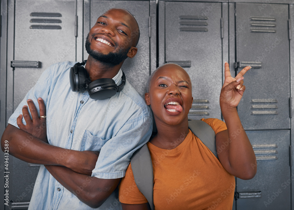 Two young black students pose with silly faces in front of campus ...