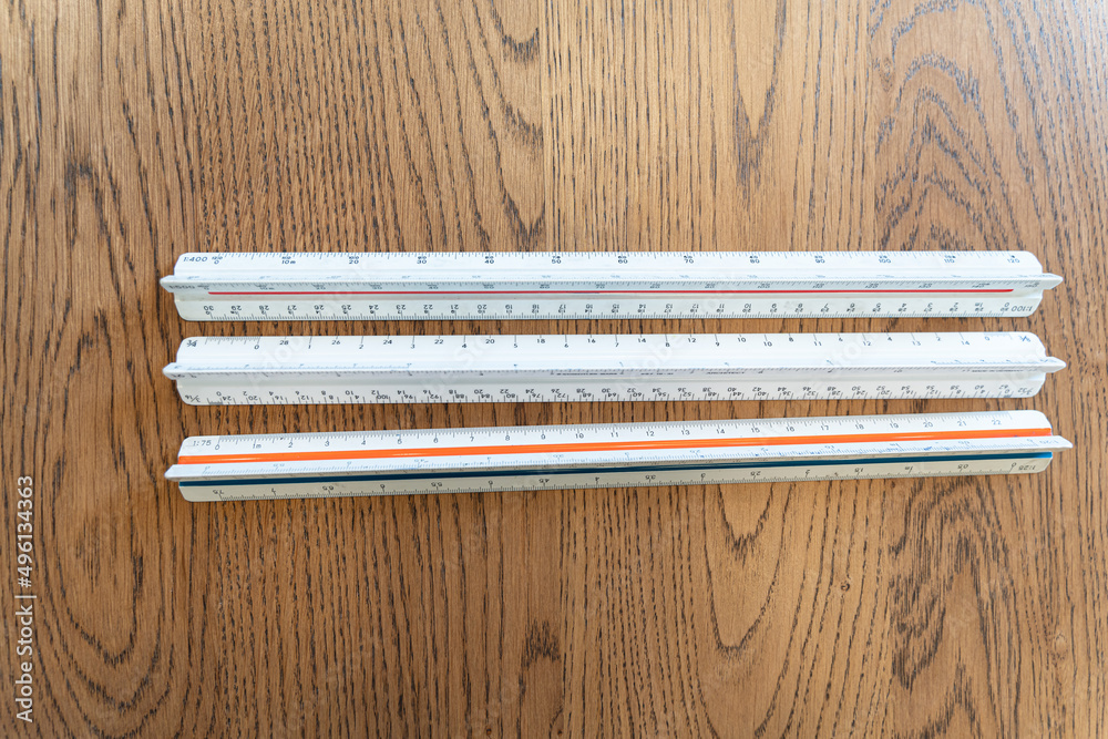 Architectural Scale Ruler with paper blueprints plans for new building ...