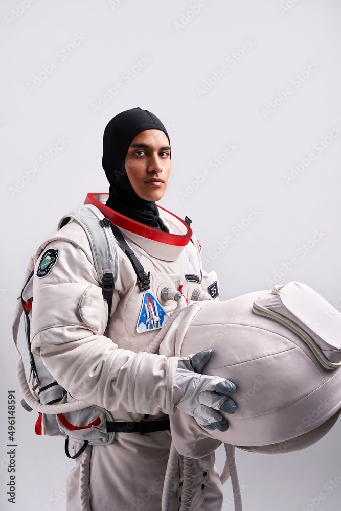 Astronaut taking off helmet of spacesuit in studio Stock Photo | Adobe ...