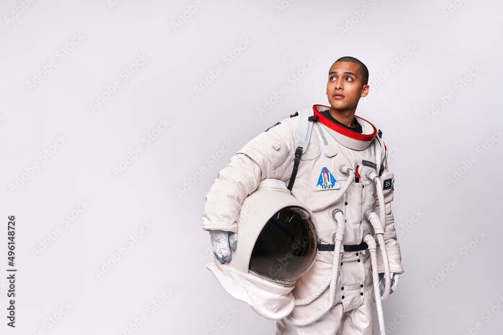 Astronaut taking off helmet of spacesuit in studio Stock Photo | Adobe ...