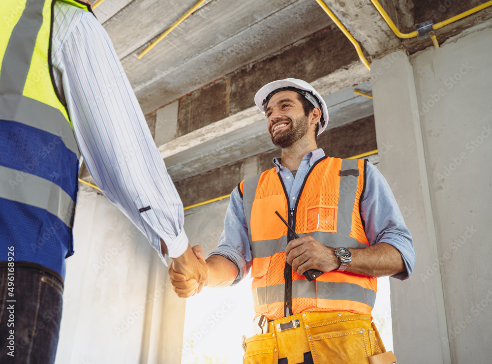Handsome construction workers in protective helmets and reflective ...