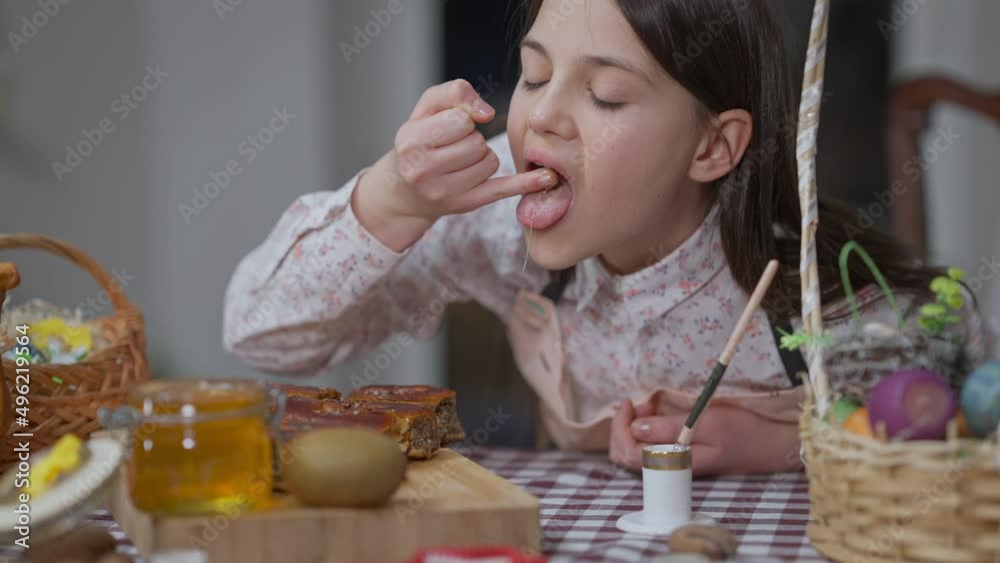 Curios teenage beautiful girl tasting delicious sweet honey with finger ...
