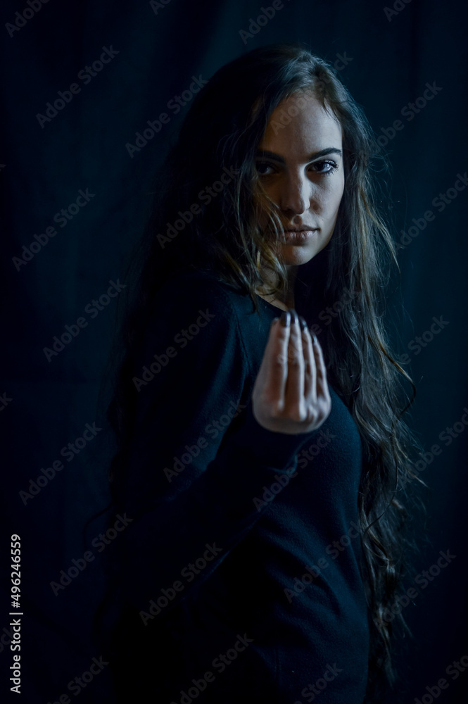 Portrait of a beautiful young Italian woman with very long hair making ...