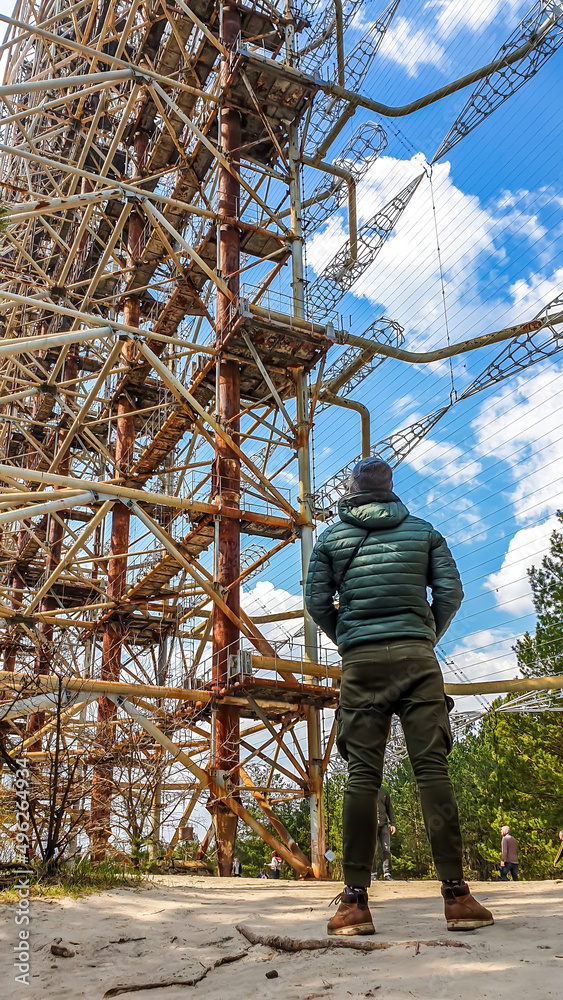 A young man standing under the Secret Soviet Radar 'DUGA-1', called a ...
