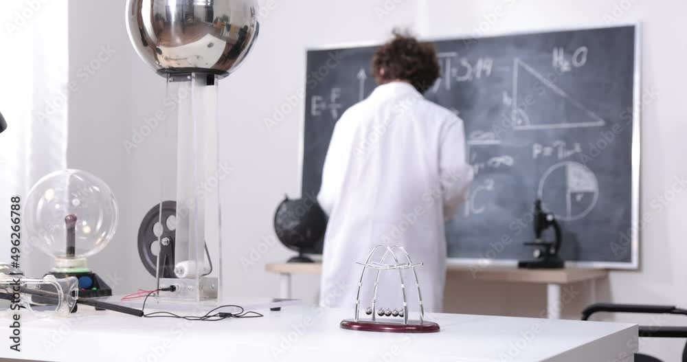 A boy conducts physical experiments with electricity, a plasma ball ...
