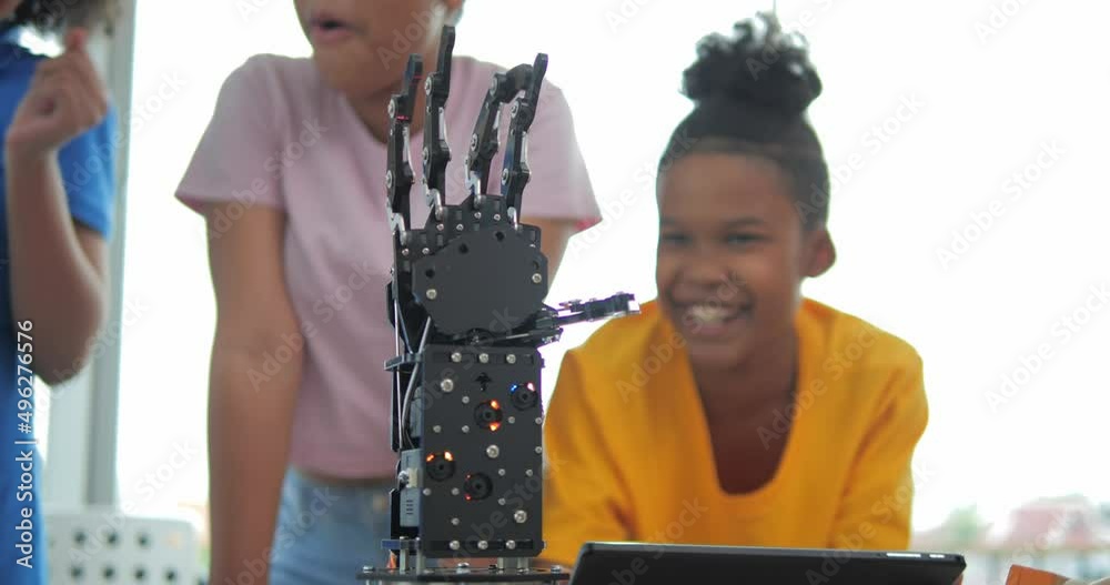Group of African black kids students learning about robotic arm school ...