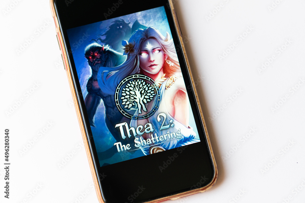 Smartphone with Thea 2: The Shattering game on display screen. Thea 2 ...