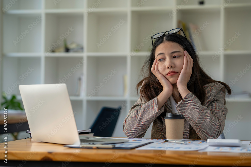 tired business woman sleepy and bored from sitting at a desk for a long ...