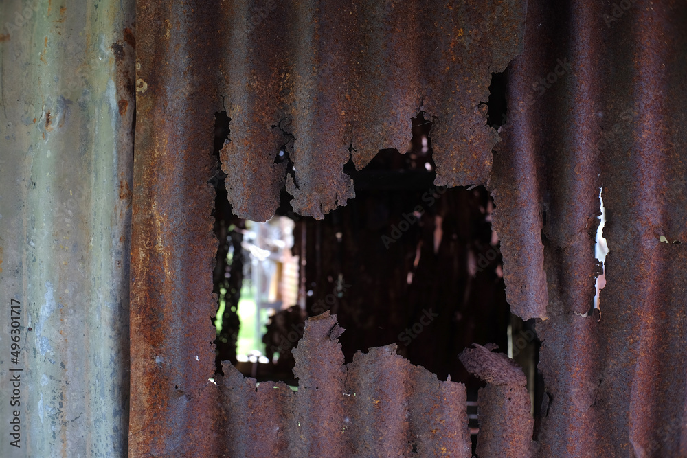 The corroded zinc walls are worn by age and weather until they collapse ...