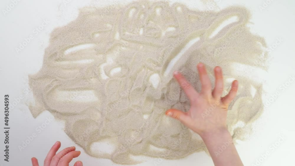 child finger drawing in sand. Top view draw on sand. Caucasian kid ...