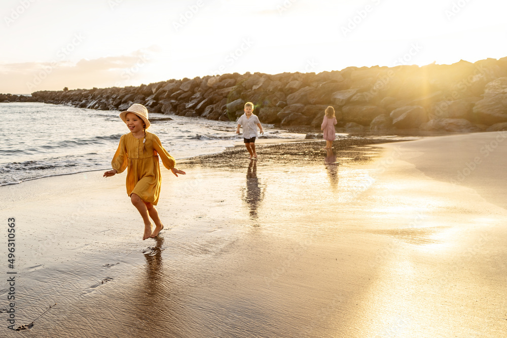 Kids playing on the beach. Little boy and girls running at sea shore at ...