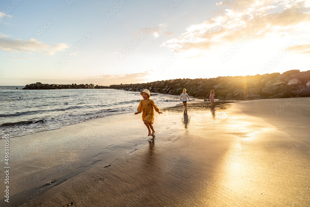 Kids playing on the beach. Little boy and girls running at sea shore at ...