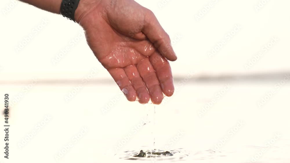 Man hand is touching water. Clean ocean. Fingers touch water in lake ...