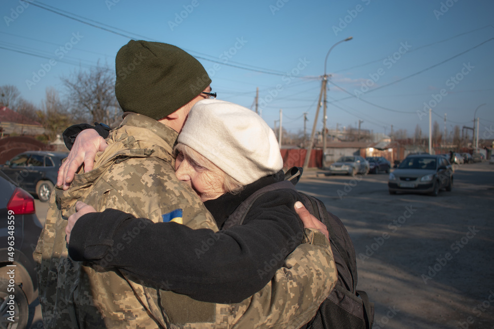 Elderly mother says goodbye to her military son. Mom hugs a Ukrainian ...