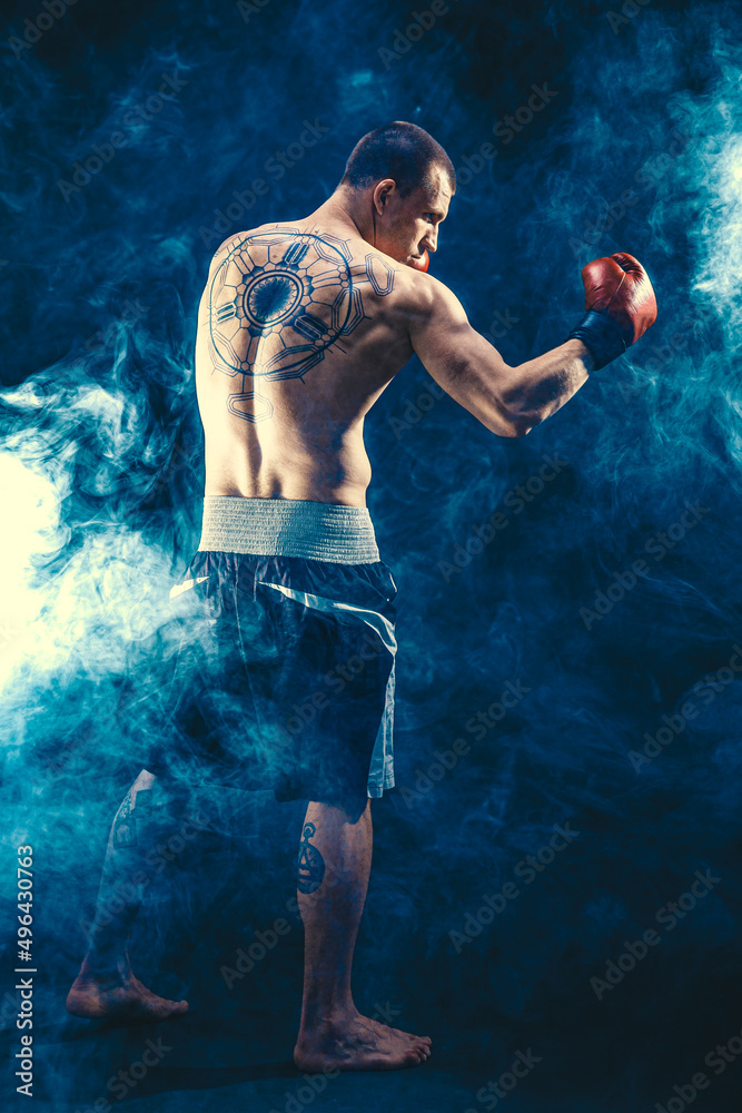 Full size of sportsman muscular boxer who fighting on black smoke ...