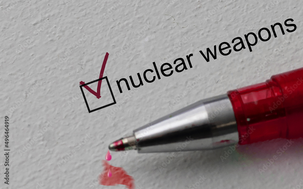 check mark on the word nuclear weapons and red pen. Closeup, concept ...
