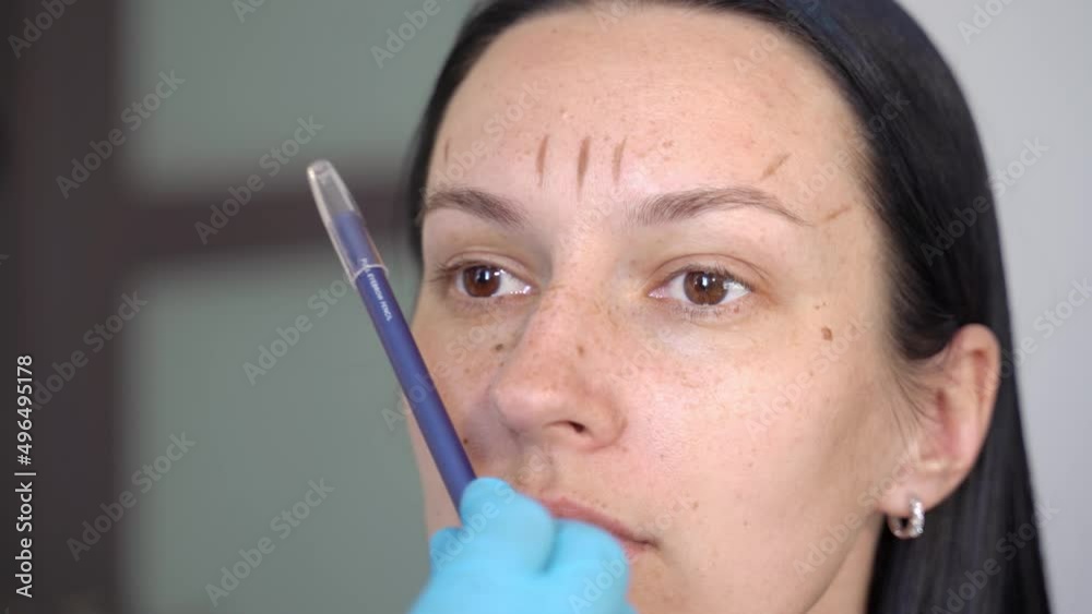 close-up of a female face on which markings are applied to build the ...