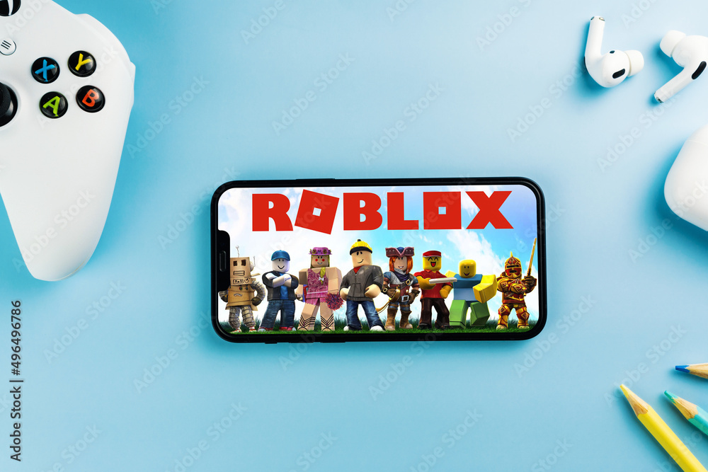 Roblox mobile game app on the smartphone screen. Blue background with ...