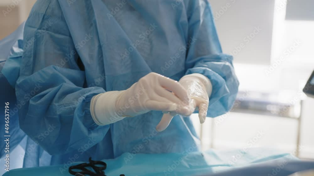 Surgeon in operation room. Doctor disinfects and washing his hands dry ...
