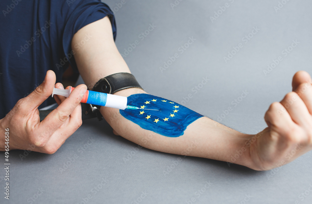 A drug addict with an image of the European flag on his arm makes an ...