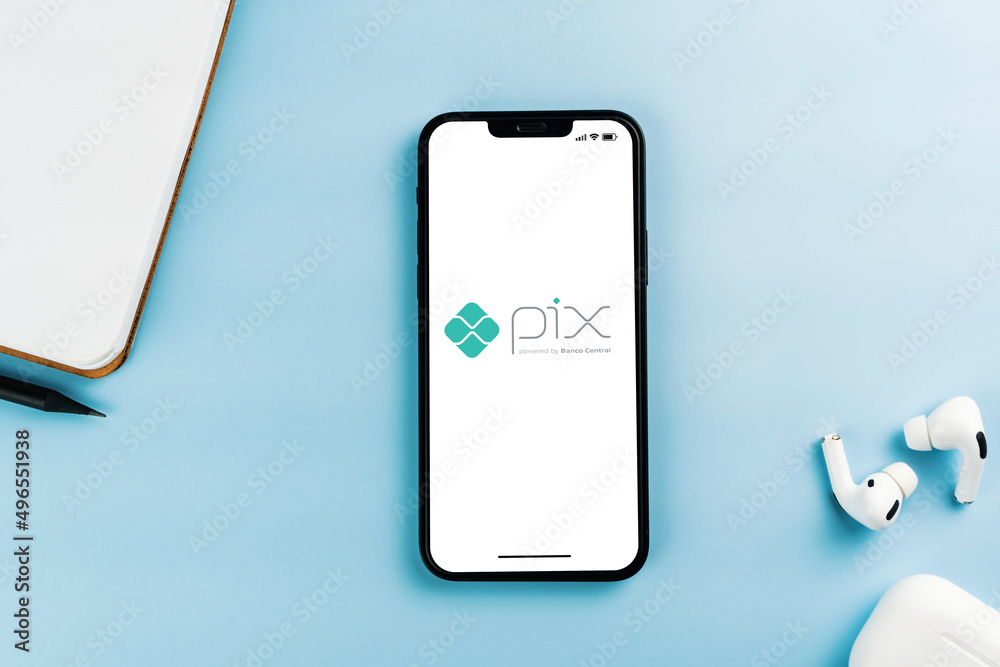 Pix app on the smartphone screen. Blue background with notepad and ...