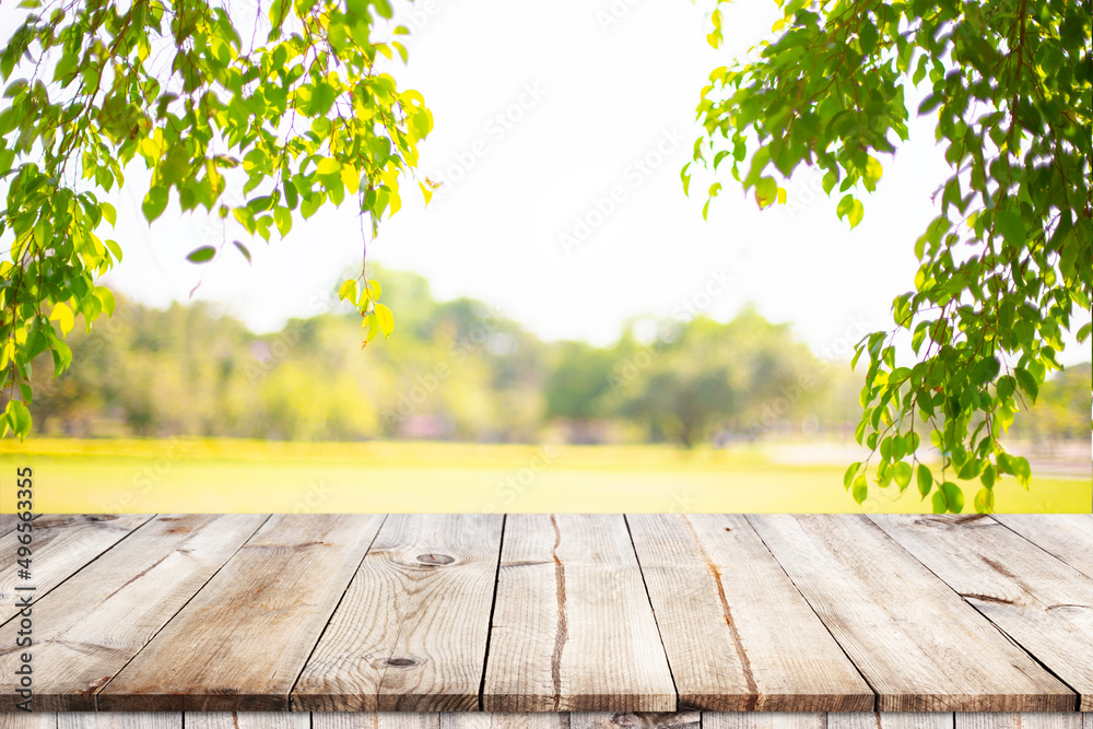 Empty wooden table with garden bokeh for a catering or food background ...