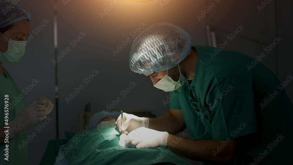 A surgeon diagnosing and identifying an elderly woman's heart problem ...
