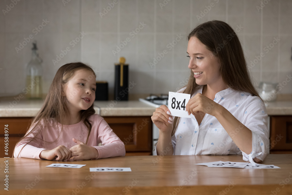 Daycare teacher and little kid girl learning math, working with ...