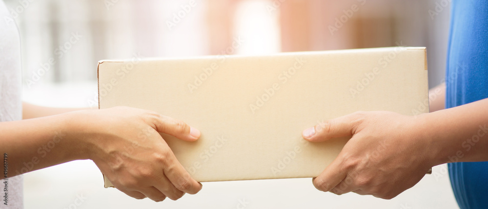 parcel delivery man of a package through a service. and close up hand ...
