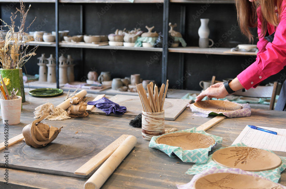 Poster Clay plates and pottery made by a young woman. – Wall Art ...