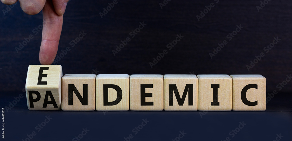 Covid-19 pandemic or endemic symbol. Turned wooden cubes and changed ...
