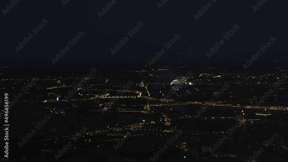 Multicolored fireworks over the night city with reflection in the ...