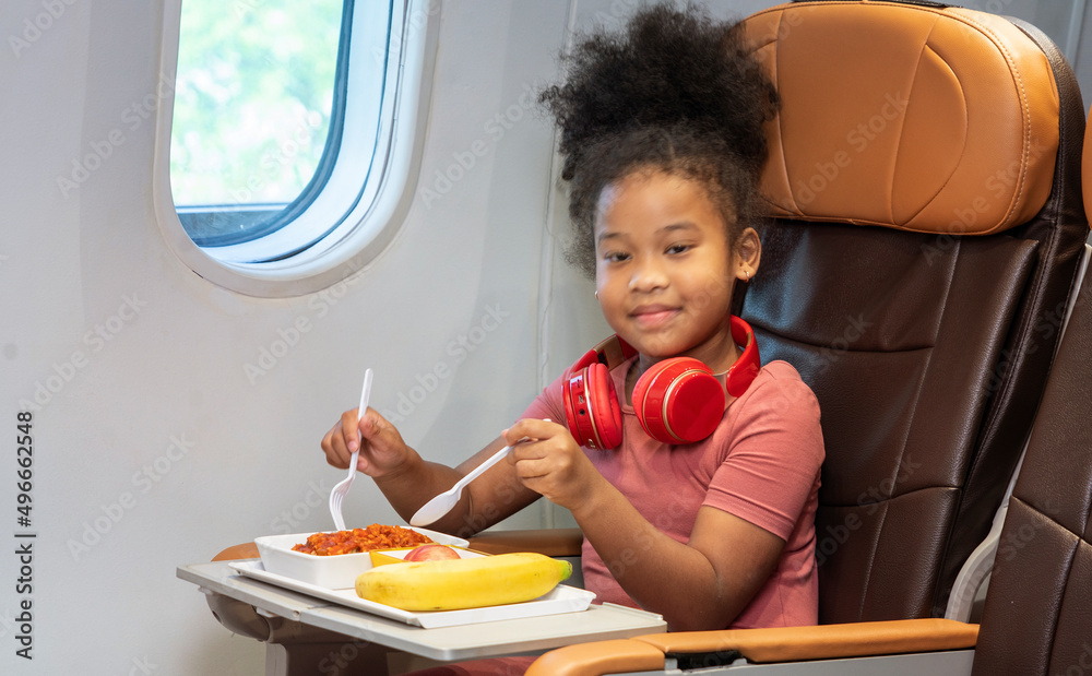 6 year old girl A year old sits on a plane, eats a delicious spaghetti ...