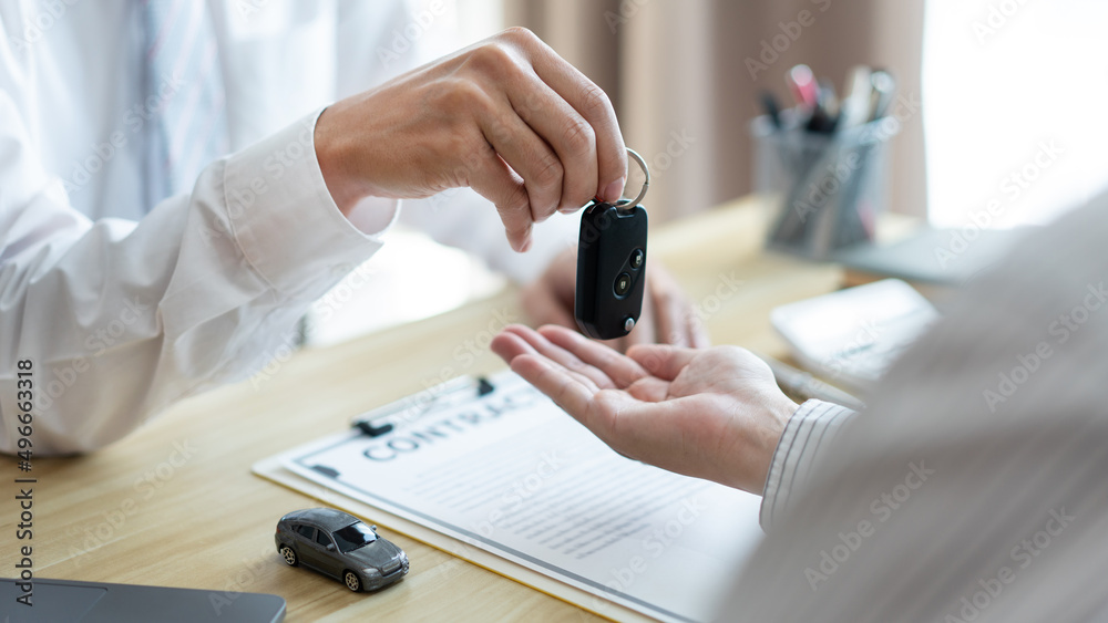 Insurance concept the customer receiving the car key after finishing ...
