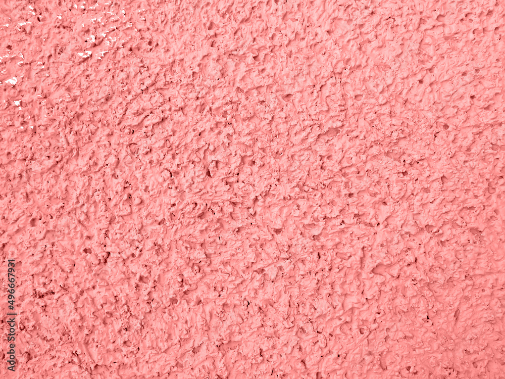 Textured pink peach colored wall cover of concrete. Facade of the ...