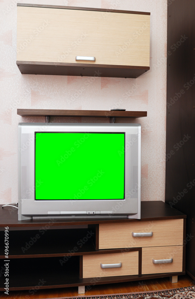 Old TV with a green screen in the interior. Stock Photo | Adobe Stock