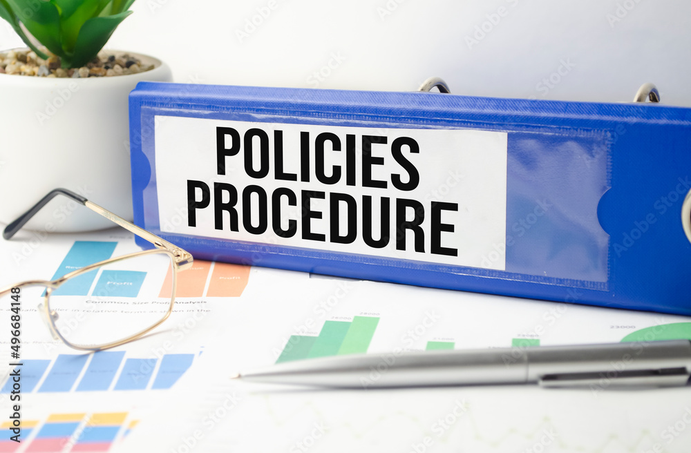 Policies and Procedure. Two binders on desk in the office. Business ...