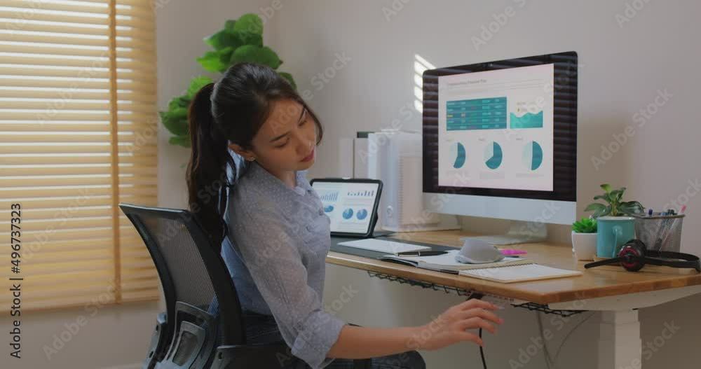 Electric adjustable standing desk in small office workspace for PC ...
