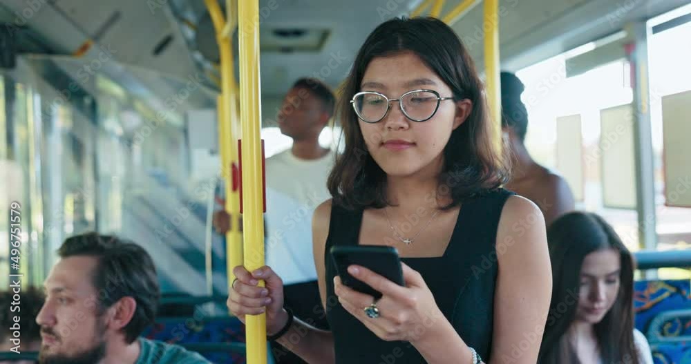 Bus stands at bus stop in city center woman with glasses using public ...