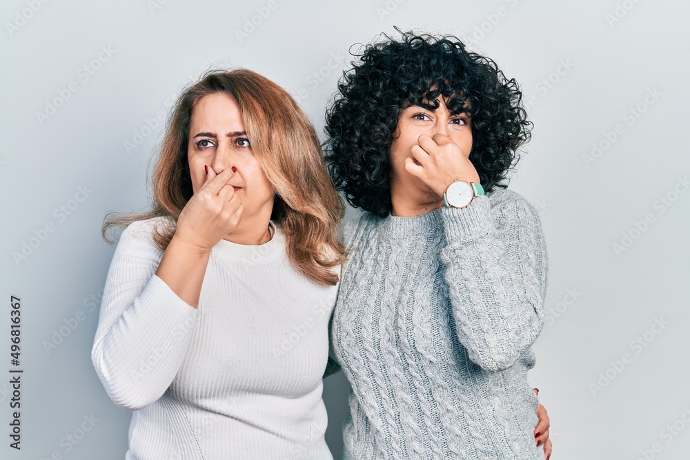 Middle east mother and daughter wearing casual clothes smelling ...