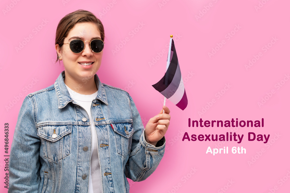 International Asexuality Day. Happy girl hold asexual flag, on pink background. Stock Photo ...