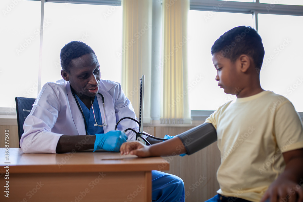 African pediatrician is measuring blood pressure and checking pulse ...