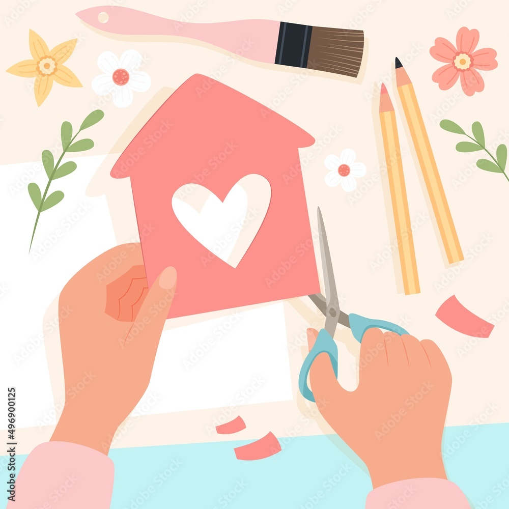 Hands cut out house of paper using scissors. Handmade hobbies, craft ...
