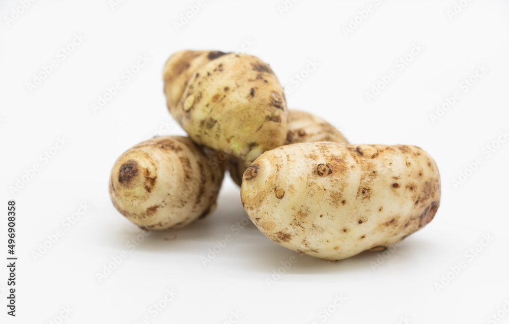 Taro or taro root also known as Arbi on white background,, its have ...